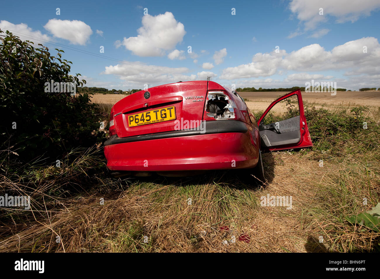 Abandoned car dumped in ditch and deliberately damaged Stock Photo - Alamy