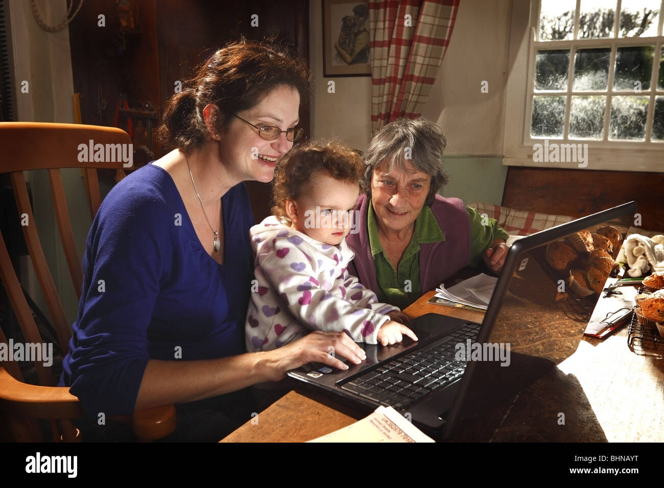 Family using a laptop computer Stock Photo - Alamy