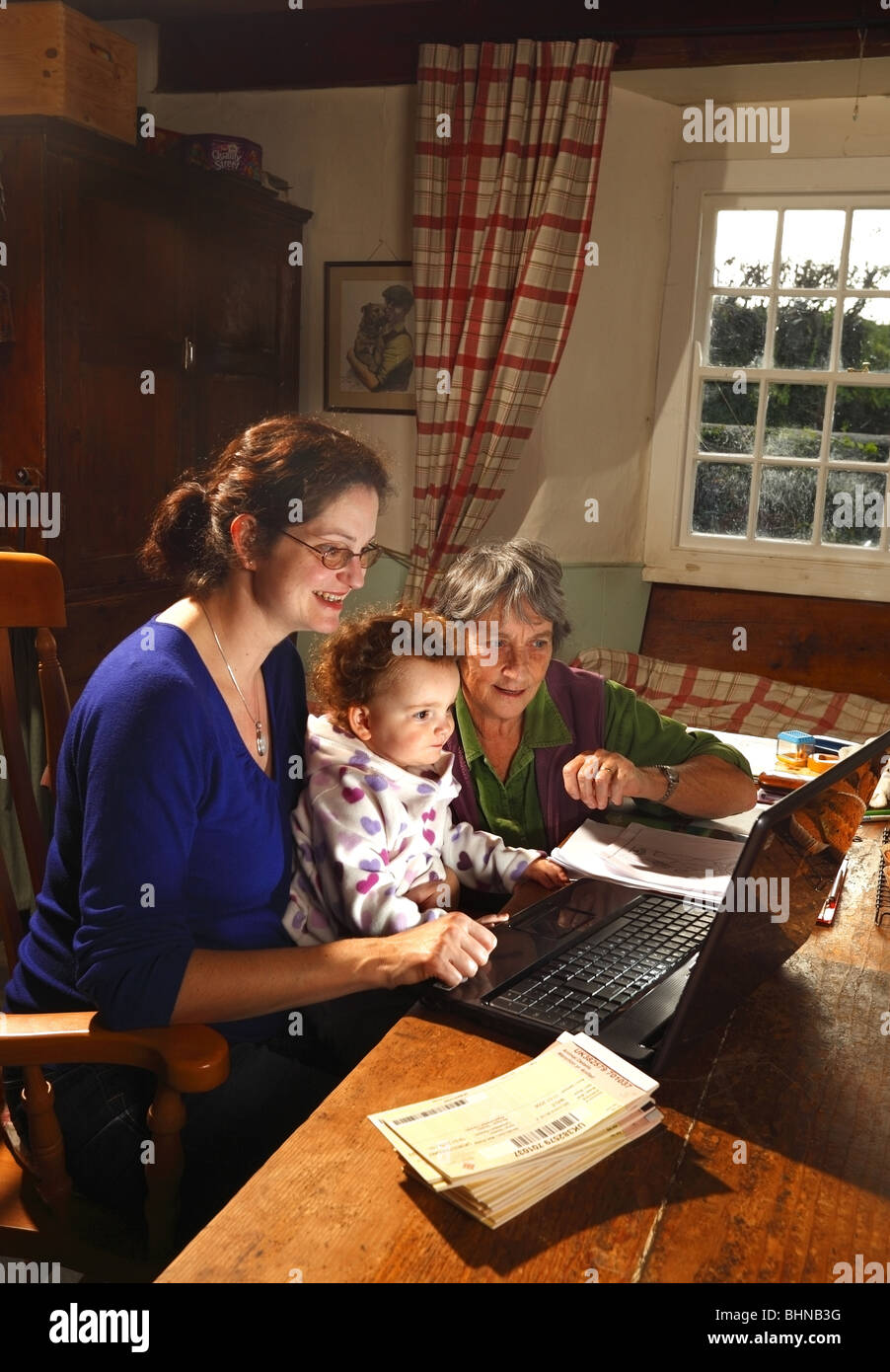 Family generations using laptop computer hi-res stock photography and ...