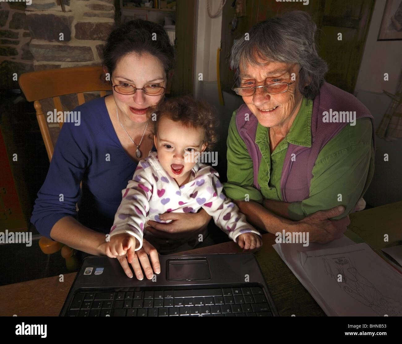 Family using a laptop computer Stock Photo - Alamy
