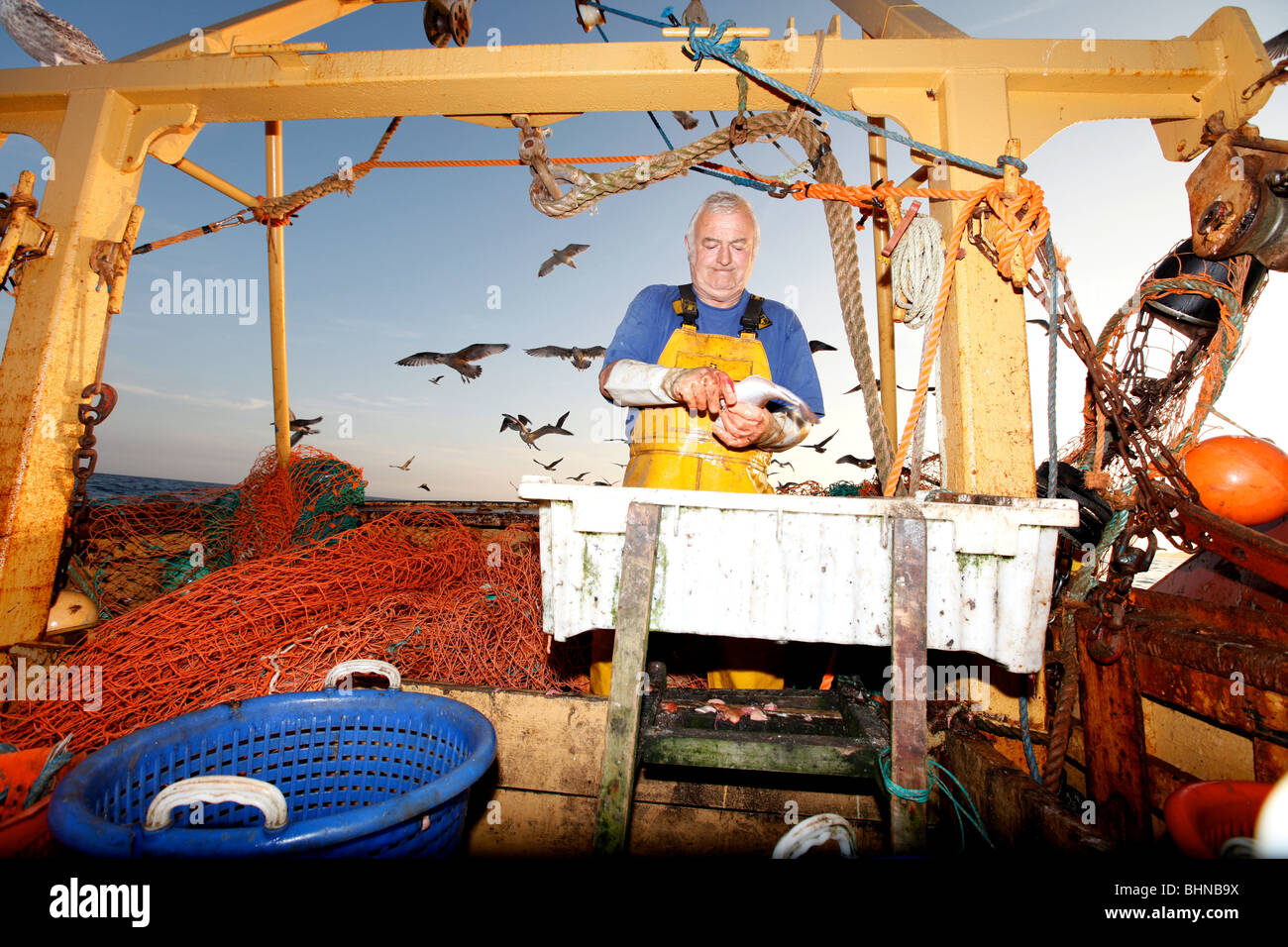 Fishermen working on a fishing boat in Mousehole, Cornwall Stock Photo ...