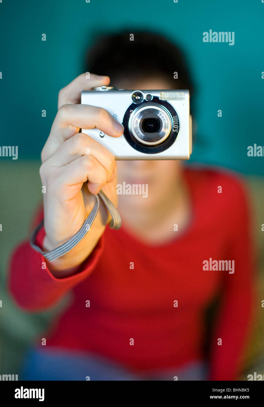 Young woman takes photo with digital camera, London - Model Released ...
