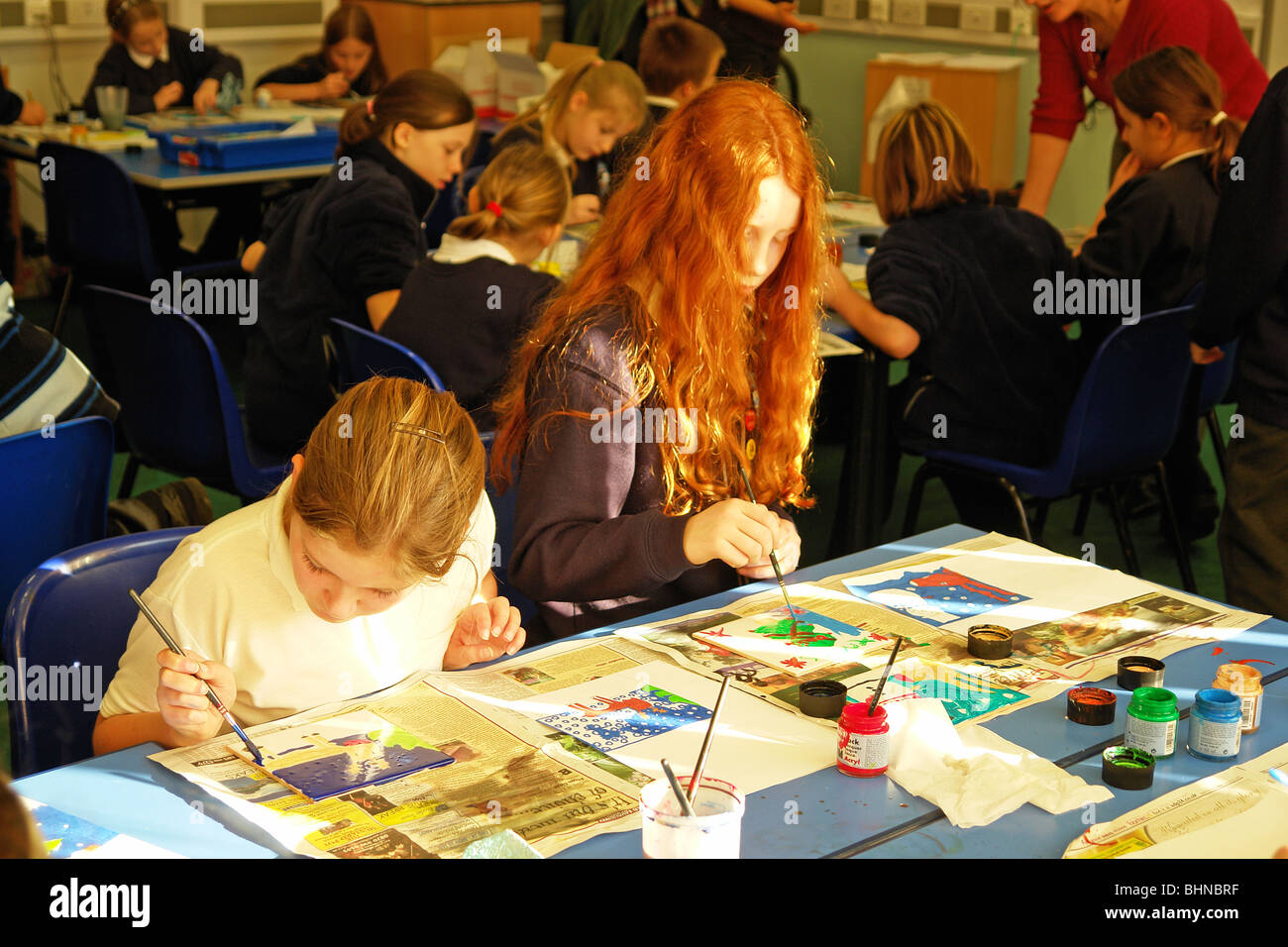 Primary school children painting in a classroom Stock Photo - Alamy