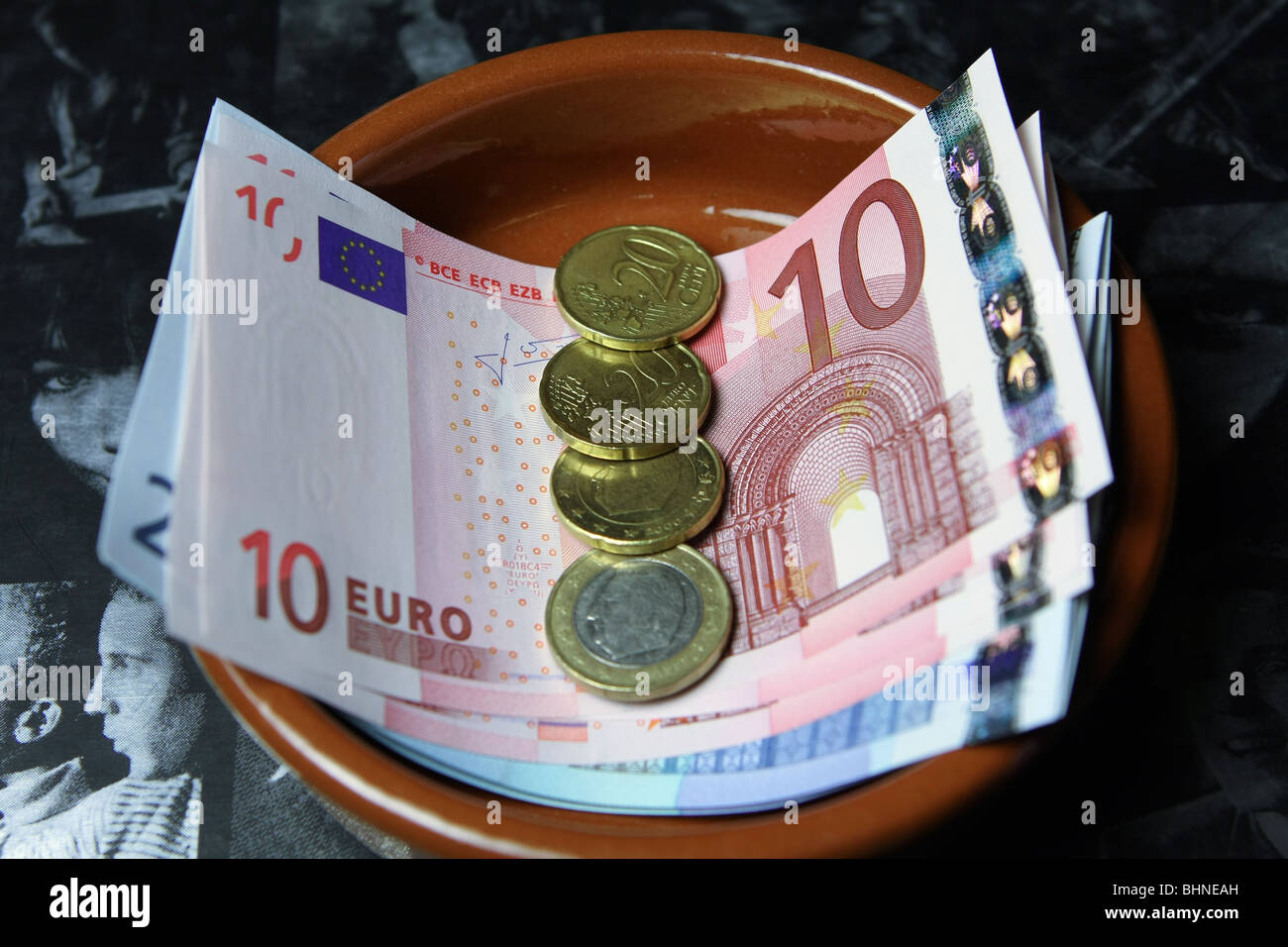 euro notes and coins in a dish on a dark page of an open book Stock ...