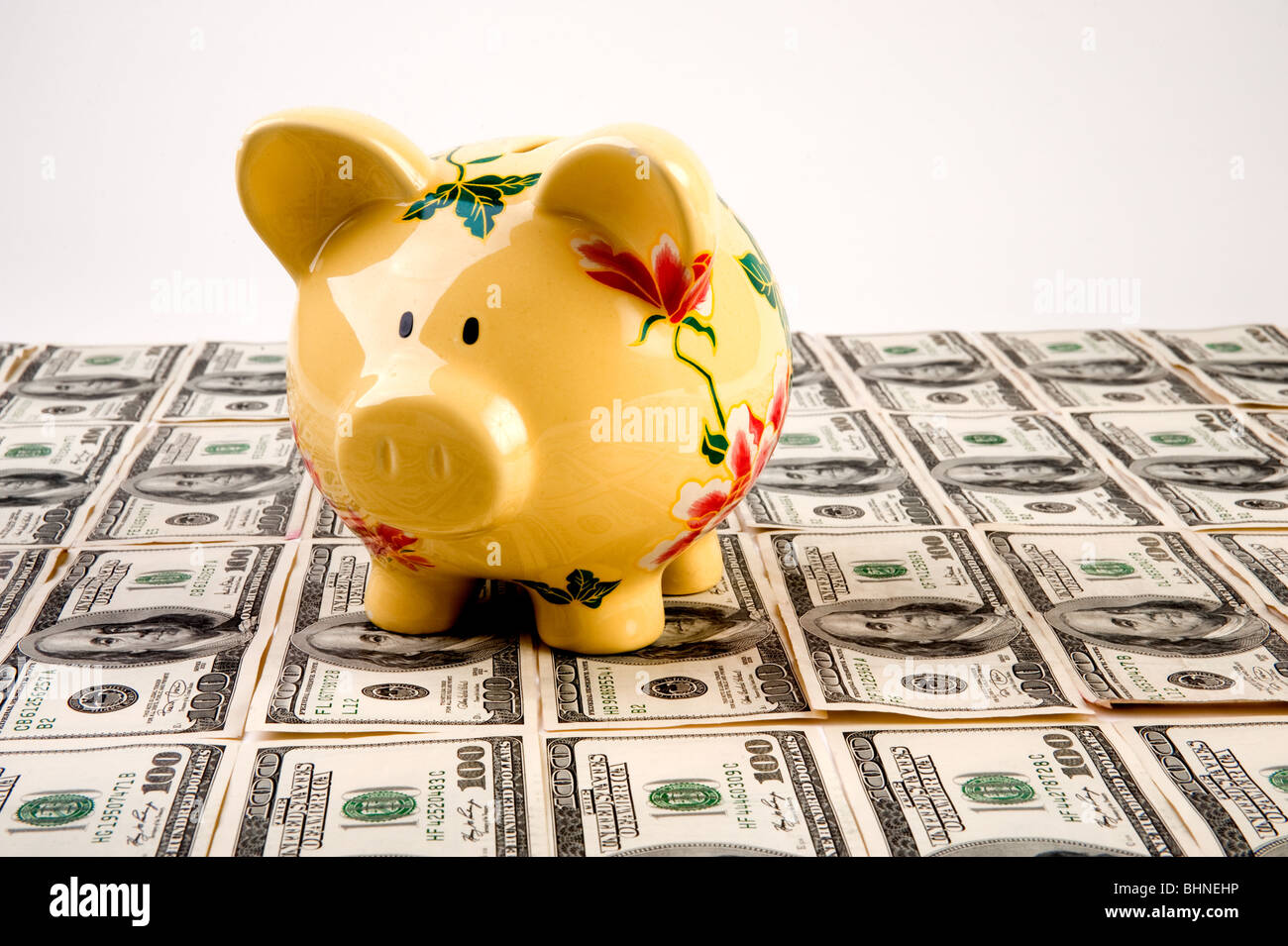 Piggy Bank sitting on top of $100 US dollar bills Stock Photo - Alamy