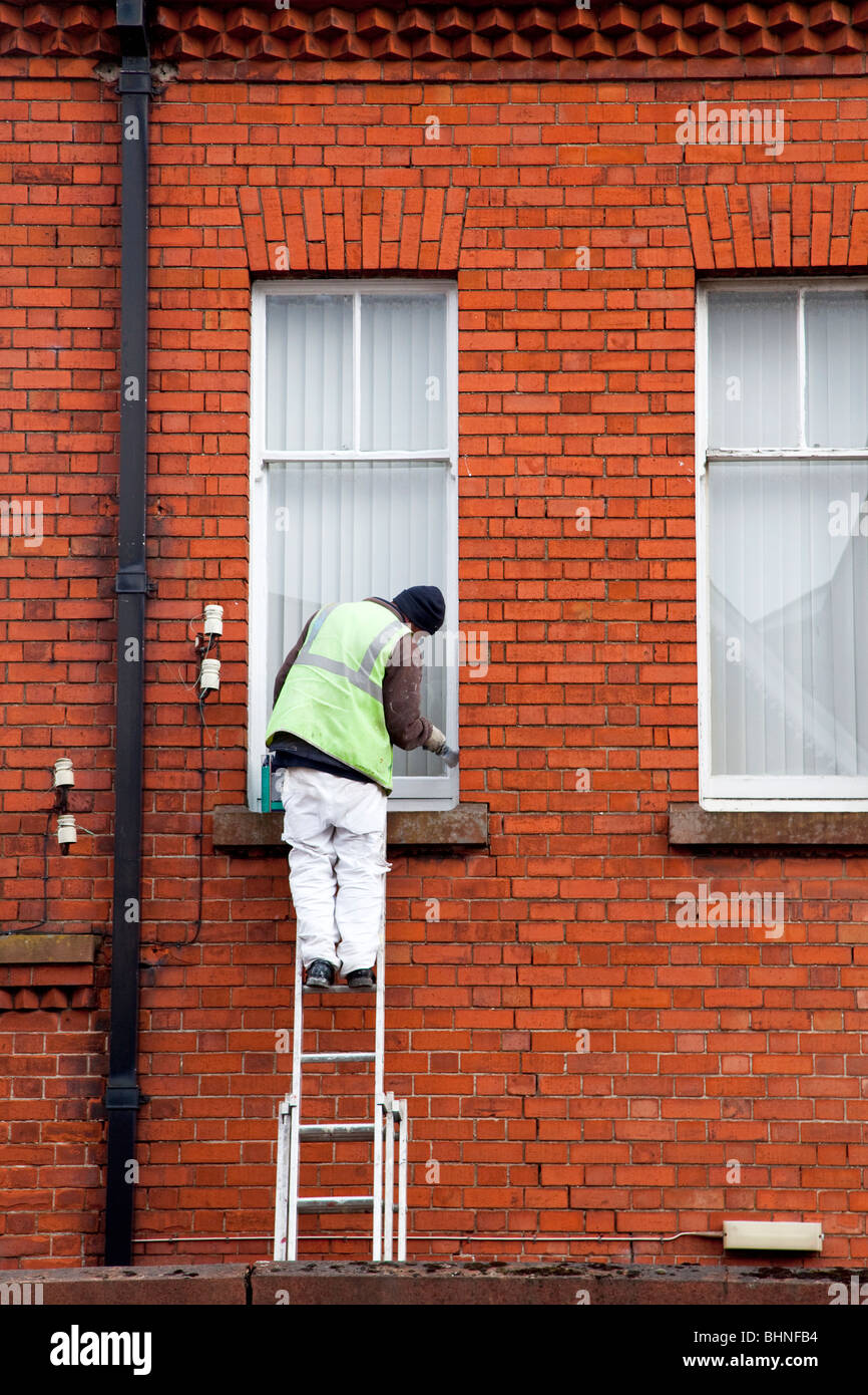 painter painting a window Stock Photo - Alamy