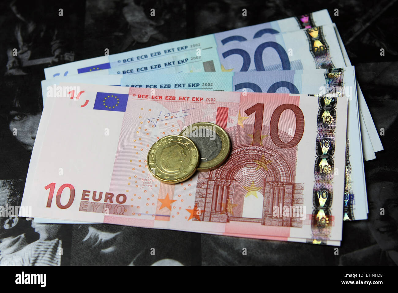 euro notes and coins in a dish on a dark page of an open book Stock ...