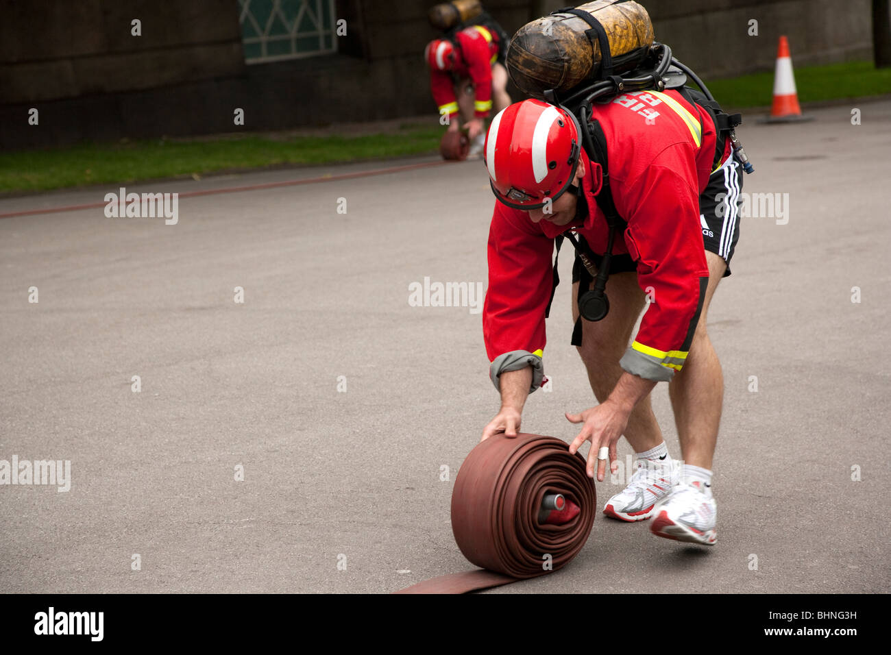 Fireman with hose hi-res stock photography and images - Alamy