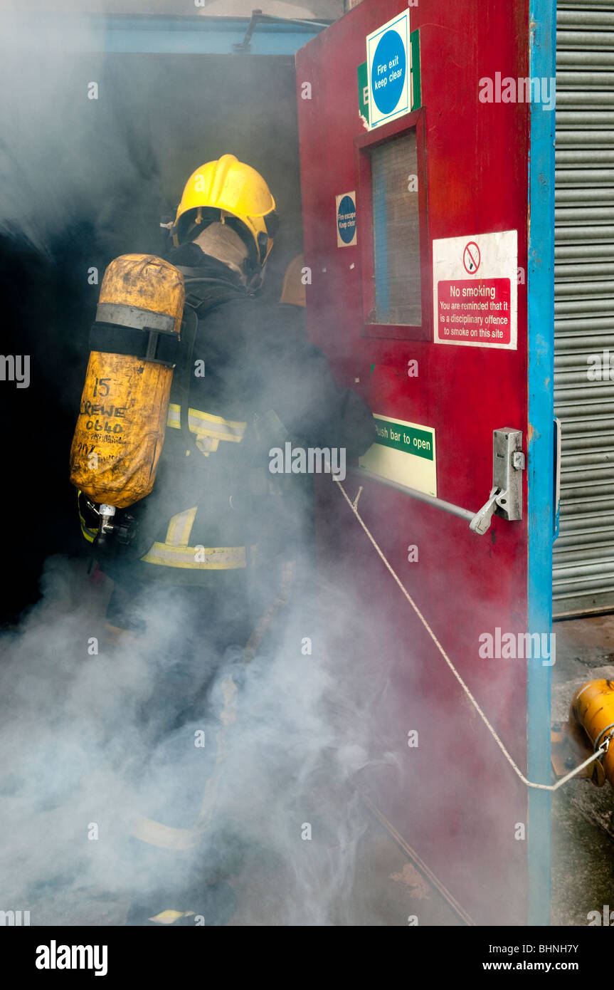 Fireman enters factory fire through fire exit door wearing BA Stock ...