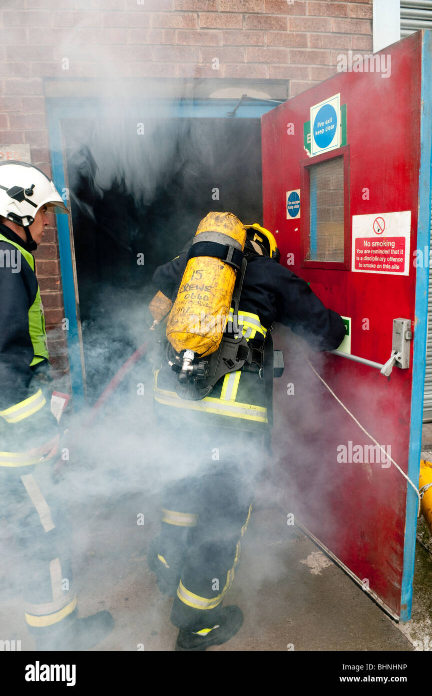 Fireman enters factory fire through fire exit door wearing BA Stock ...