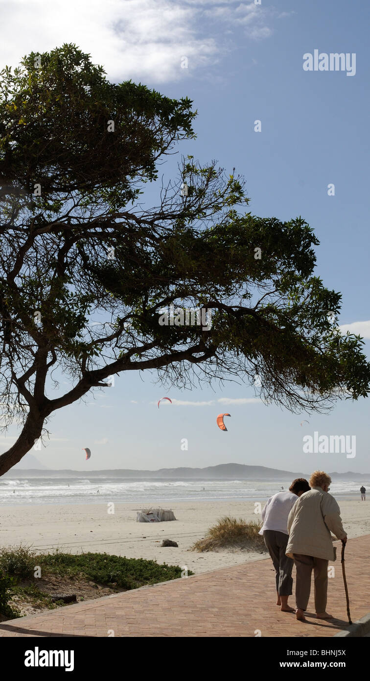 Elderly women walking along the promenade at Strand a seaside resort in ...