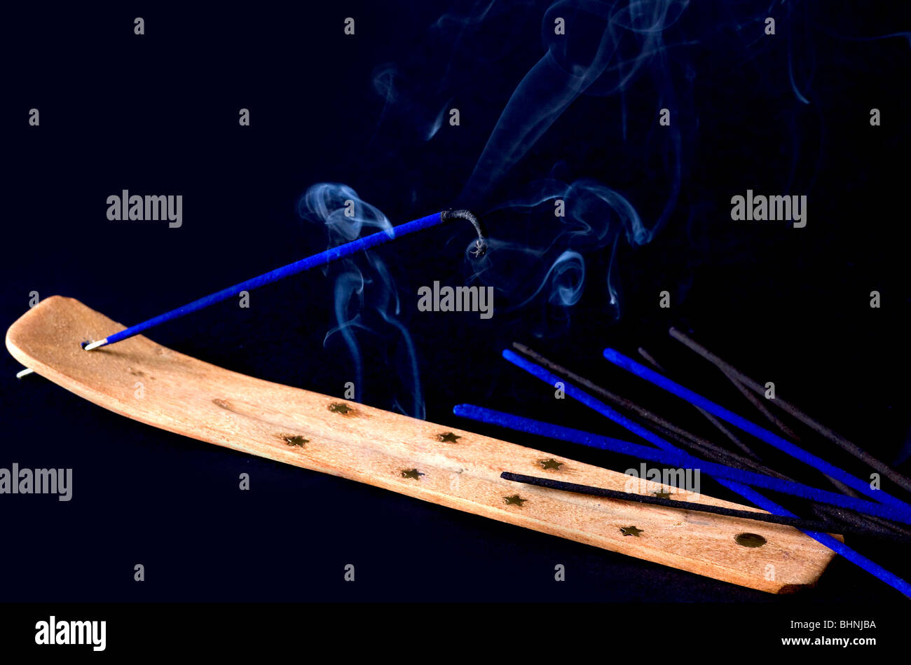Wooden Incense with smoke on black background Stock Photo - Alamy