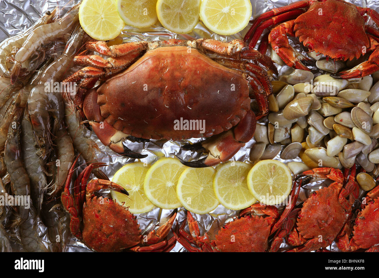 Crabs tellin shrimp clams and lemon seafood still life Stock Photo - Alamy