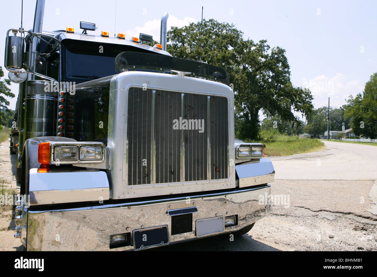 Black huge lorry american truck with stainelss steel in green outdoor ...