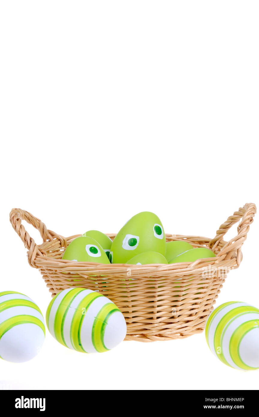 Eggs in the green Easter basket. Painted eggs Stock Photo - Alamy