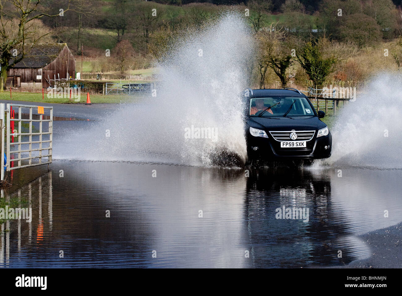 VW Motor Vehicle travelling at speed through flooded grounds in ...