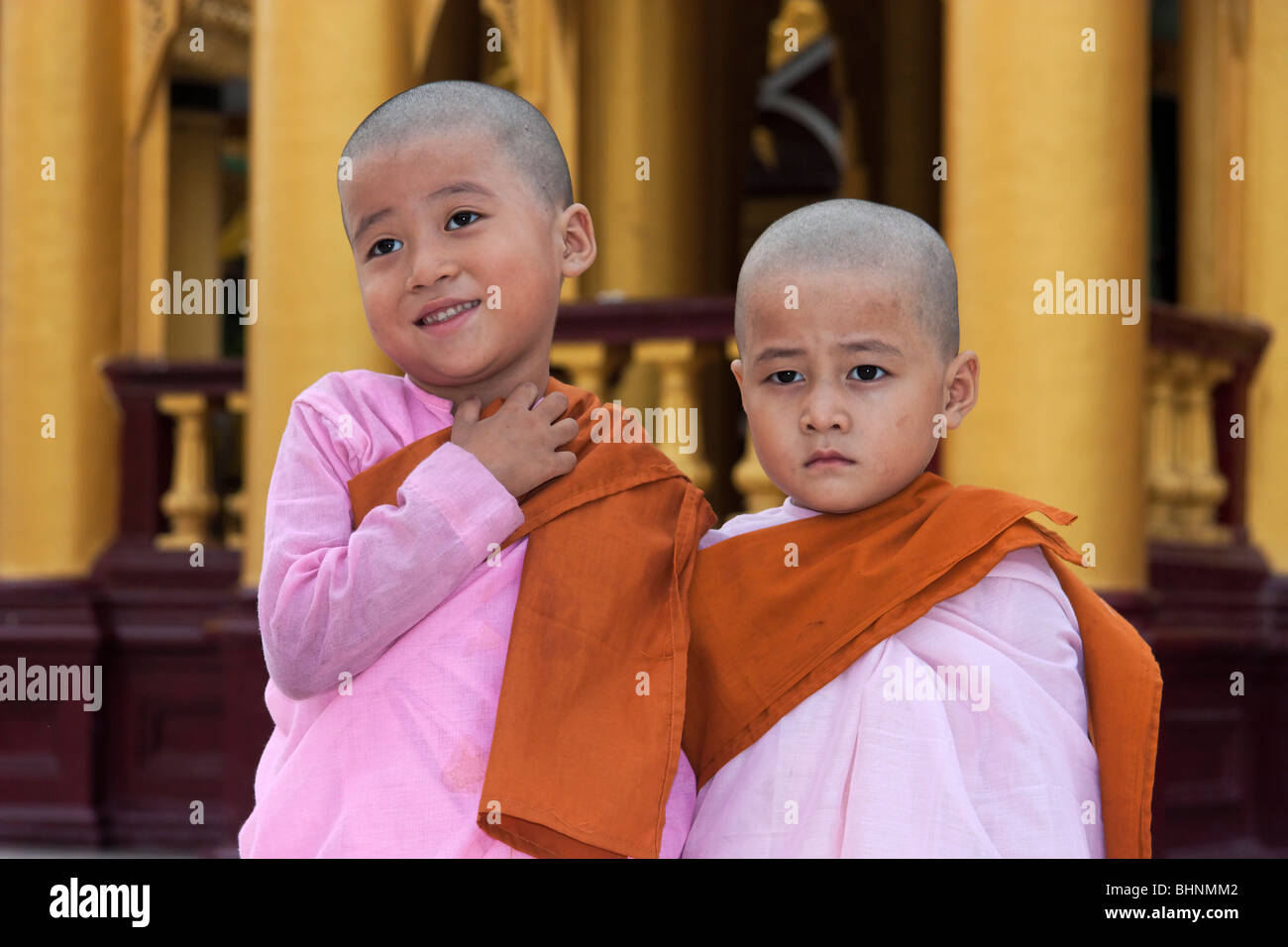 Two young monks in pink robes Stock Photo - Alamy