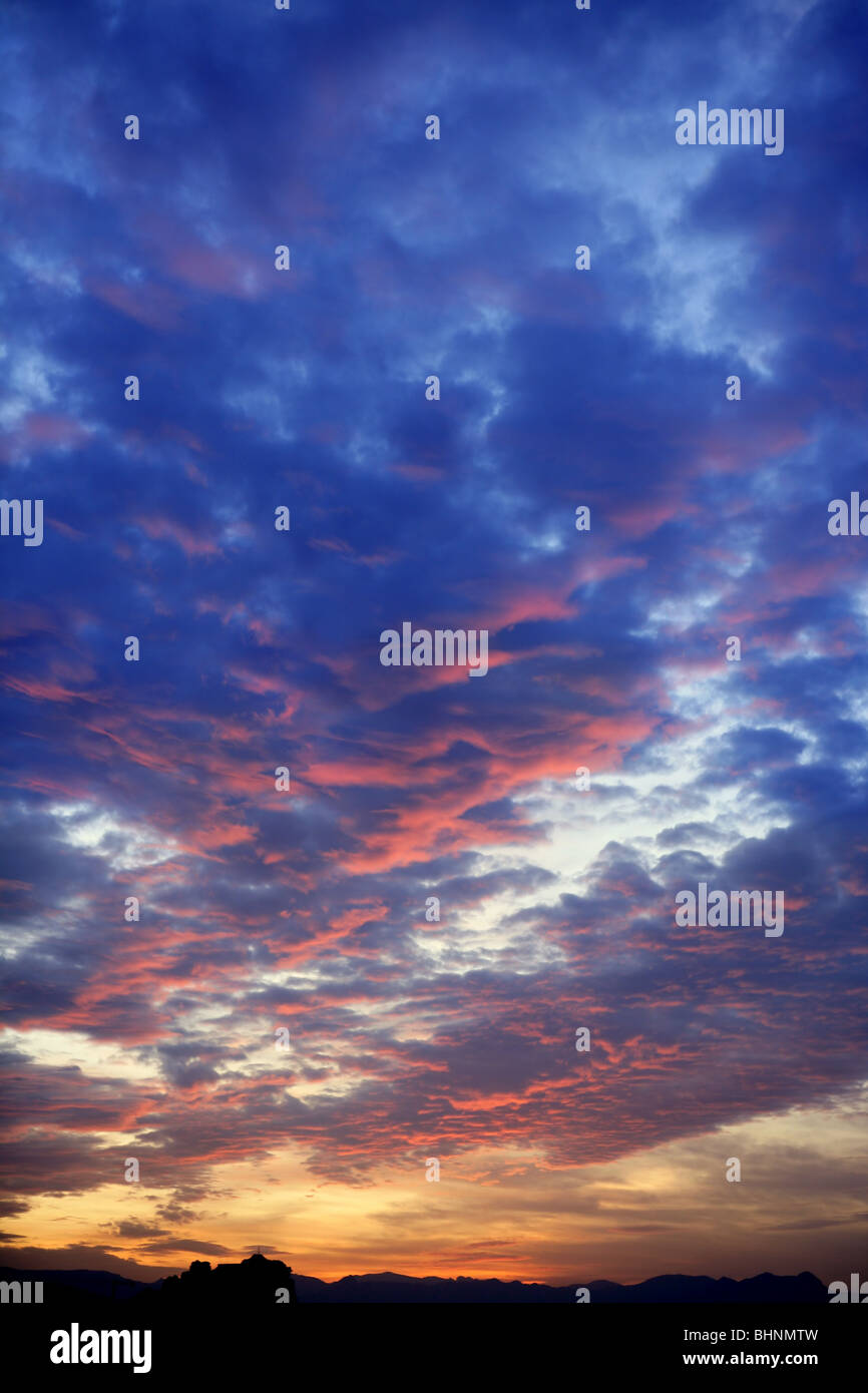 Colorful red blue sunset cloudy sky dramatic light Stock Photo - Alamy