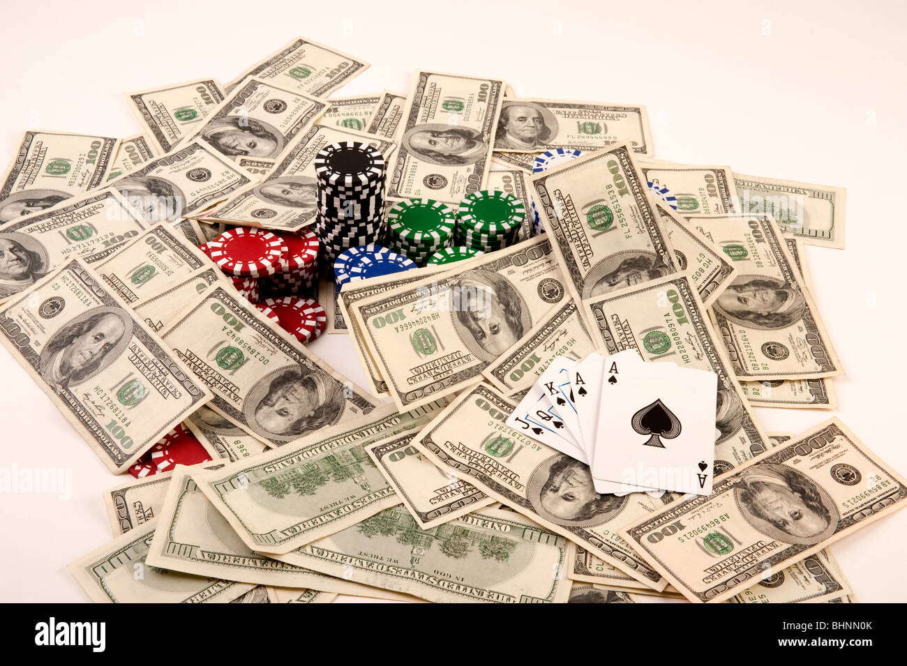 Winning poker hand in a pile of $100 dollar bills with chips Stock ...