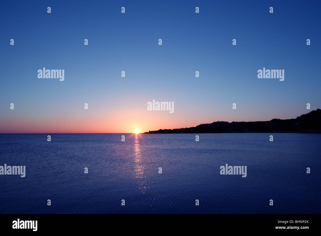 Beautiful sunset sunrise over blue sea ocean in red sky Stock Photo - Alamy