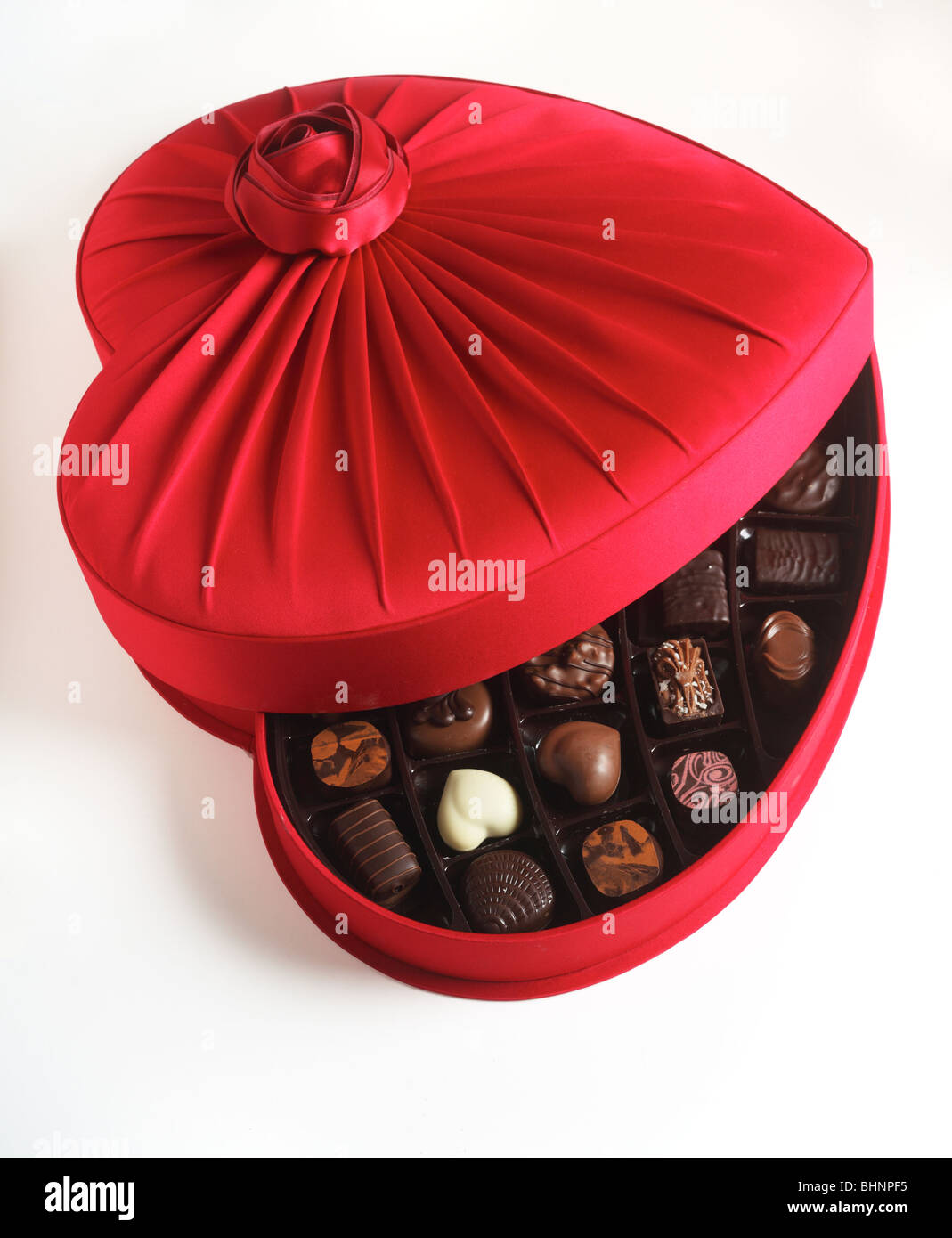 An opened red heart-shaped box of luxury chocolates Stock Photo - Alamy