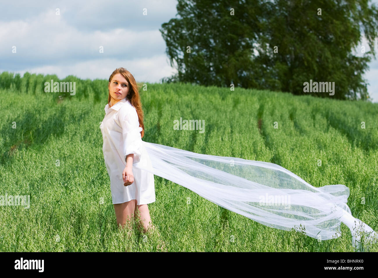 Woman walking field blue sky scarf hi-res stock photography and images ...