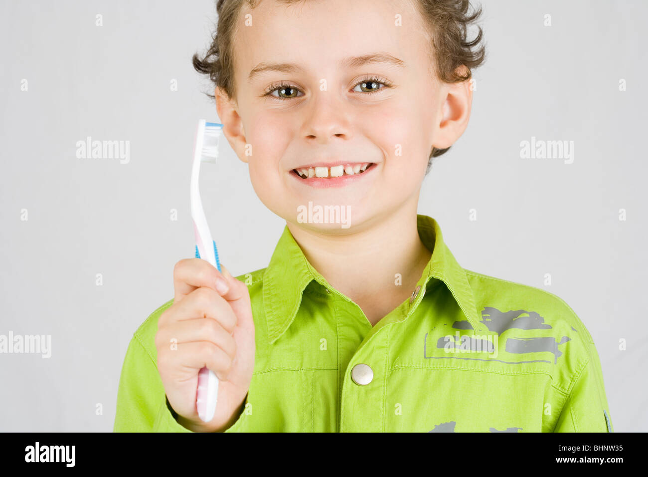 Beautiful boy brushing teeth, isolated on white Stock Photo - Alamy