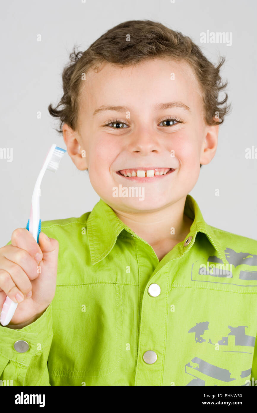 Beautiful boy brushing teeth, isolated on white Stock Photo - Alamy