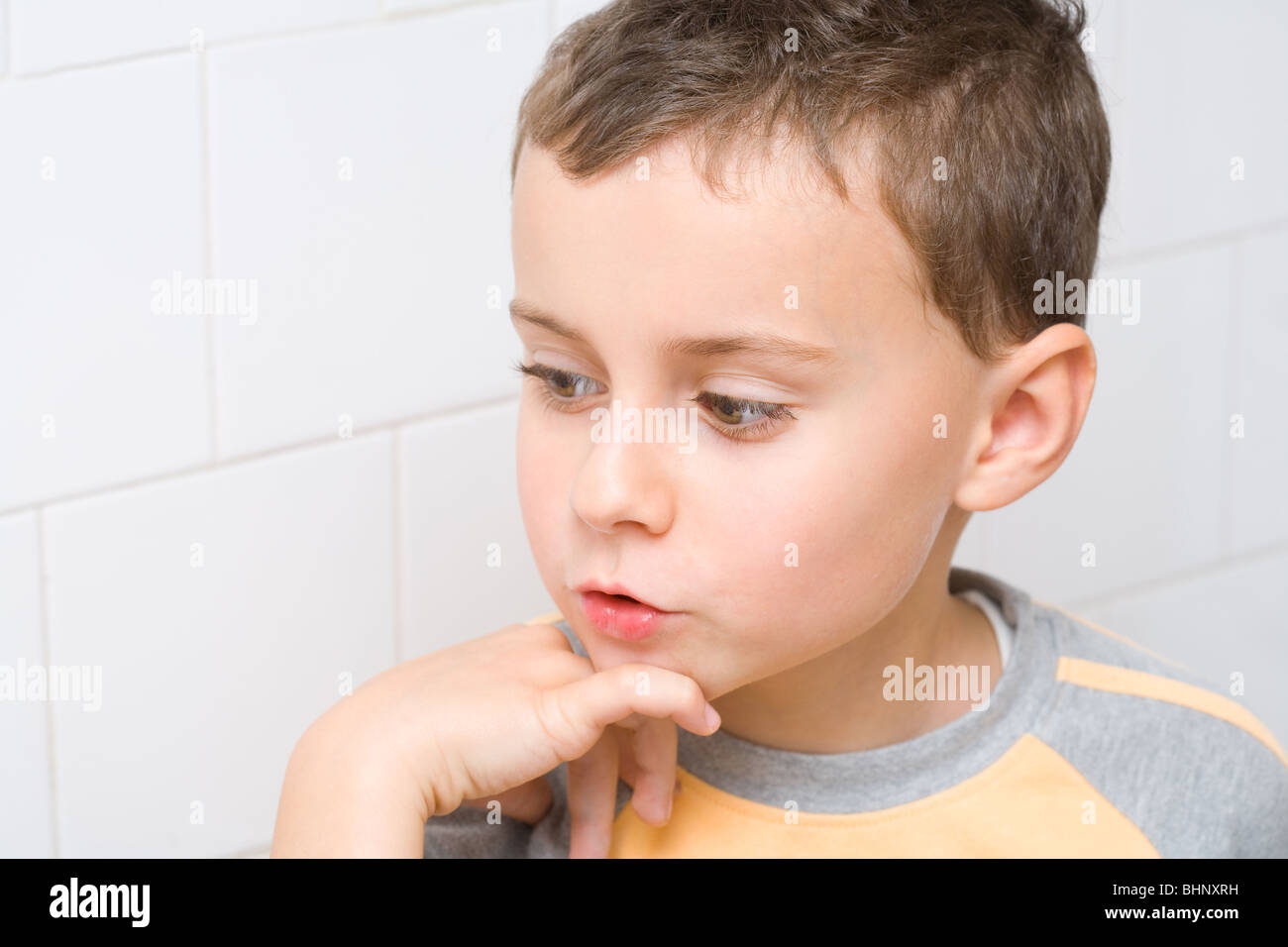 Closeup portrait of a pensive little boy indoor Stock Photo - Alamy