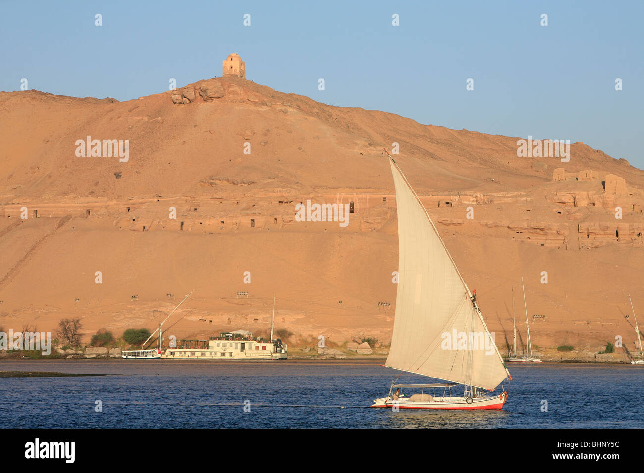 Felucca sailing early in the morning on the Nile past the Tombs of the ...