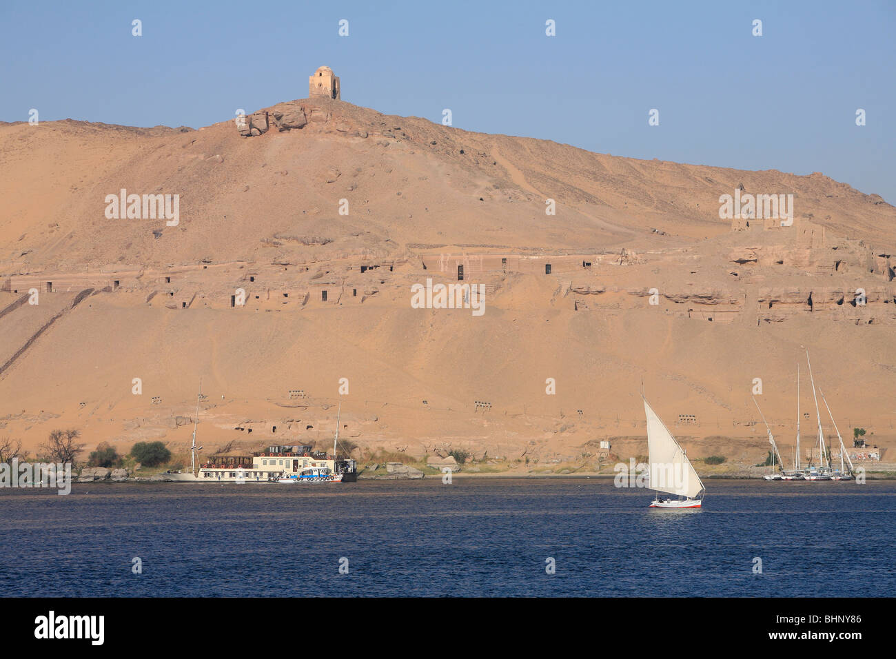 Felucca sailing early in the morning on the Nile past the Tombs of the ...