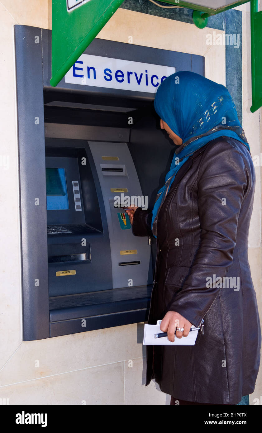Arab woman in veil using bank ATM card in Tunis Tunisia in Northern ...