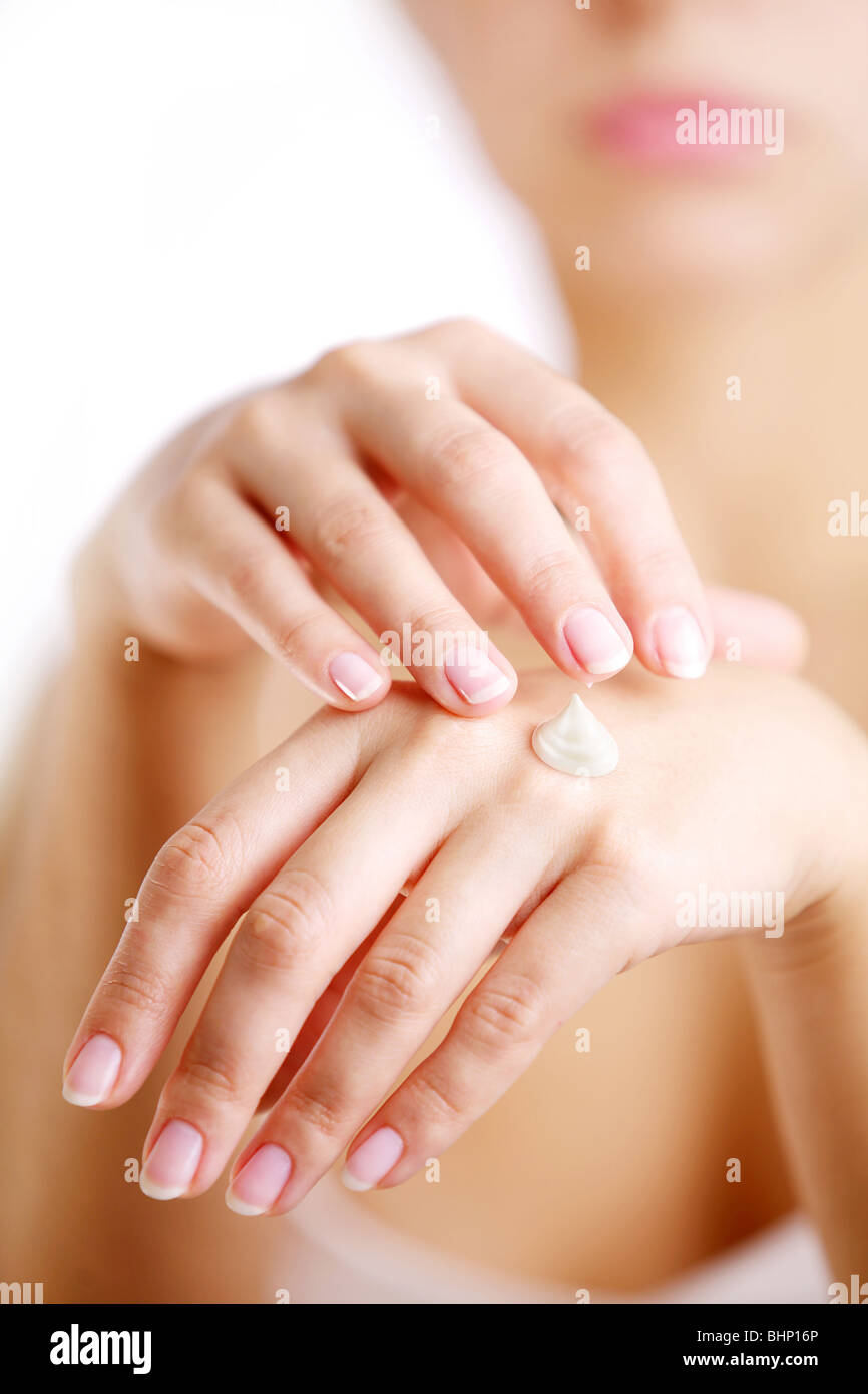 Young woman cares about her hands, applying cream on them Stock Photo ...