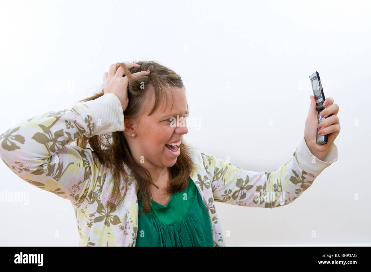 young woman angry with mobile phone Stock Photo - Alamy
