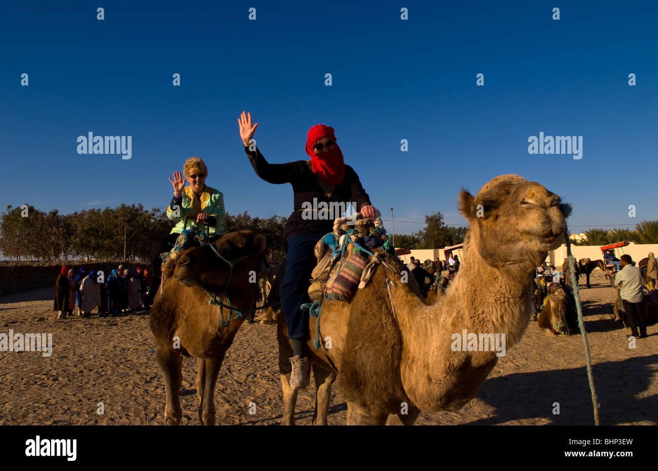 Tourists on camel ride in Douz in Sahara Desert in Tunisia Africa Stock ...