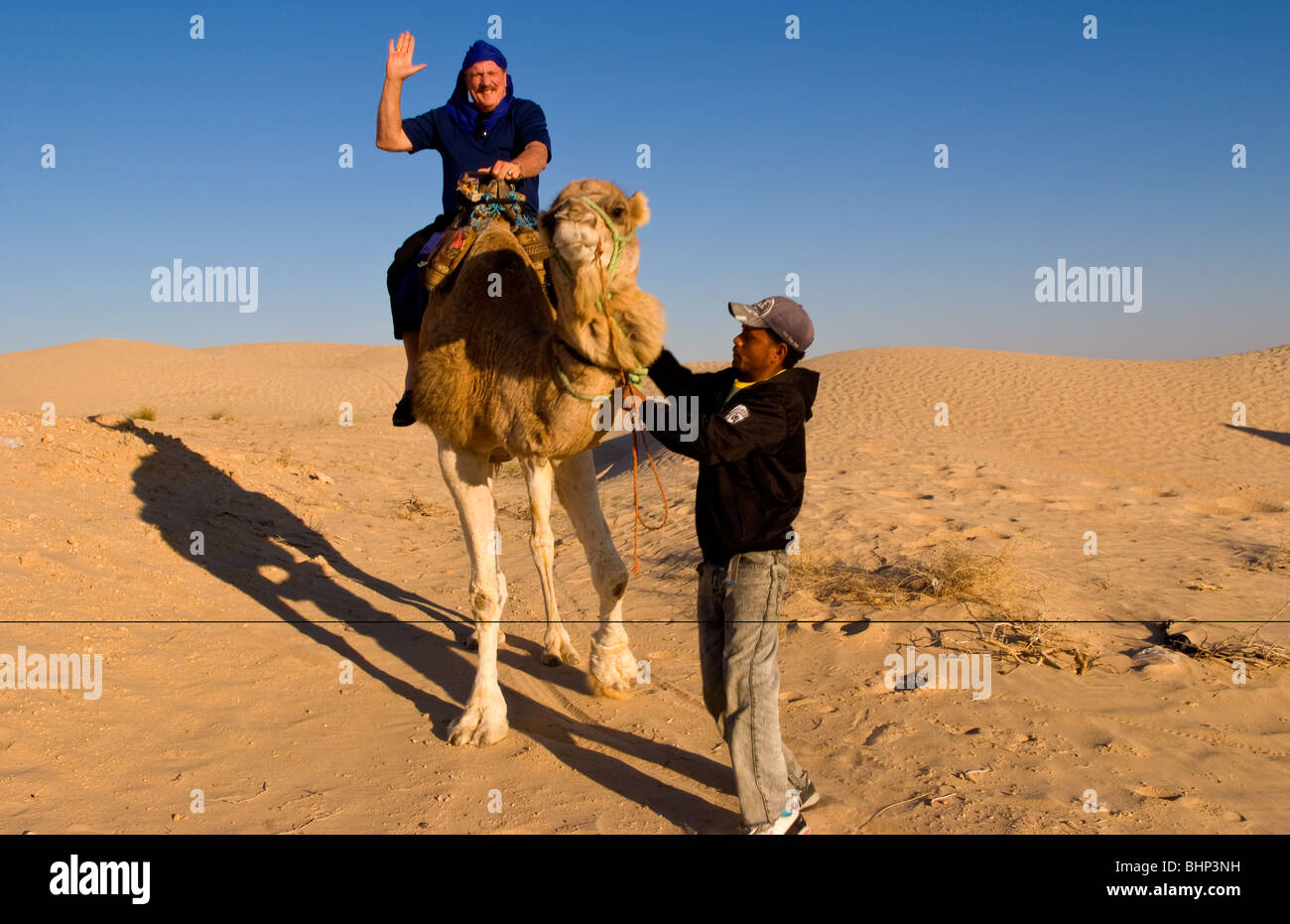 Tourists on camel ride in Douz in Sahara Desert in Tunisia Africa Stock ...
