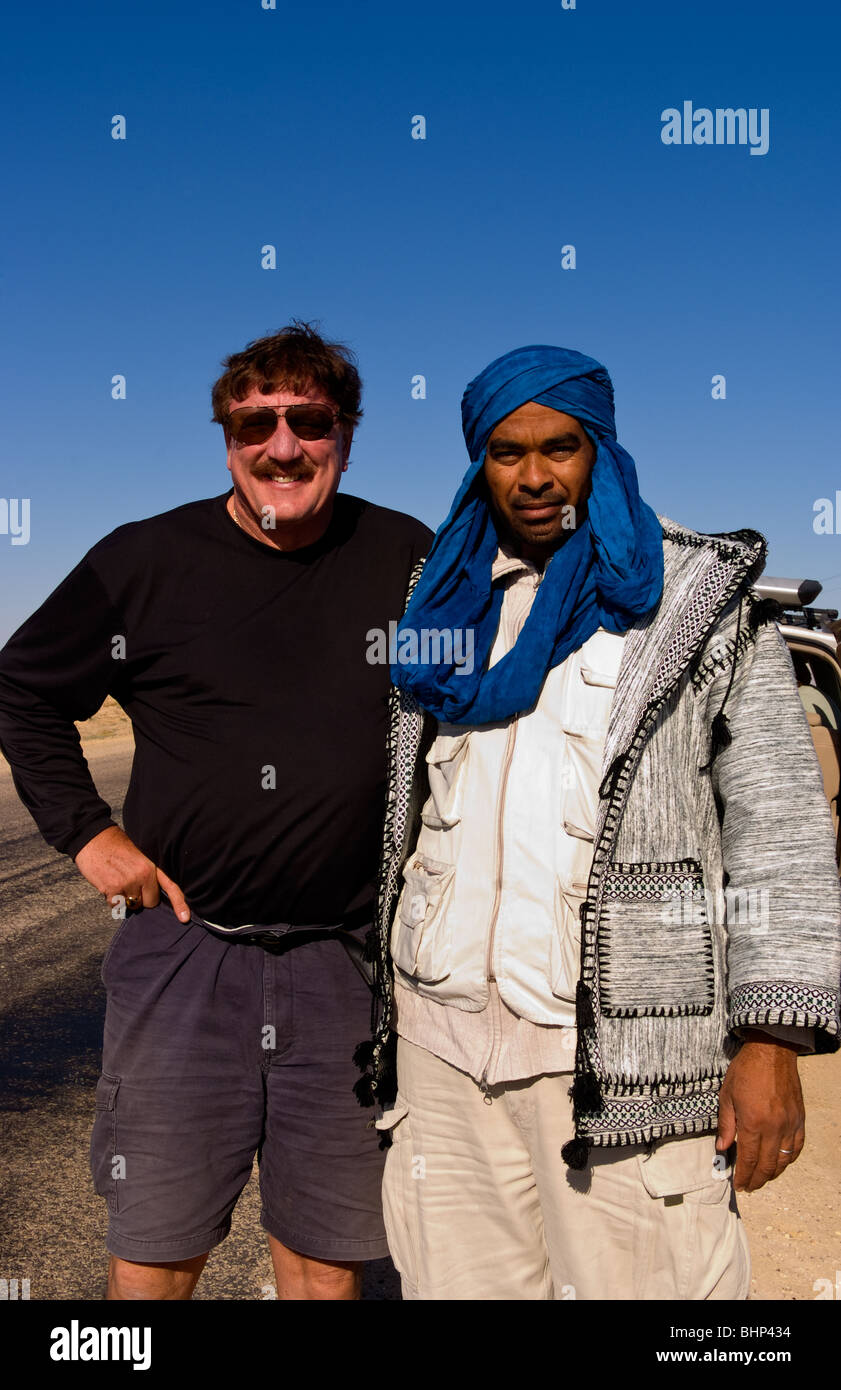Tourist man with Arab man in Sahara desert near Tozeur Tunisia Africa ...