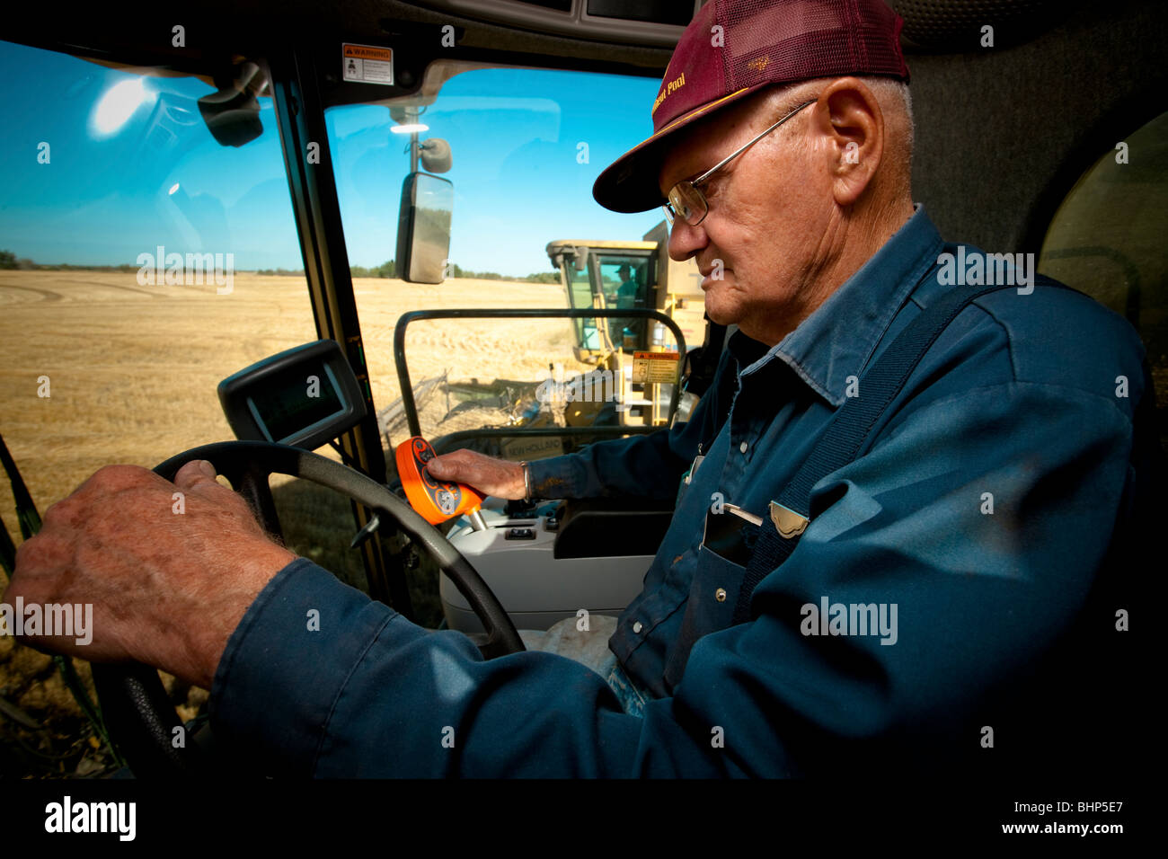 Senior Farmer In Cab Of Combine, With Second Combine Parallel, Redvers ...