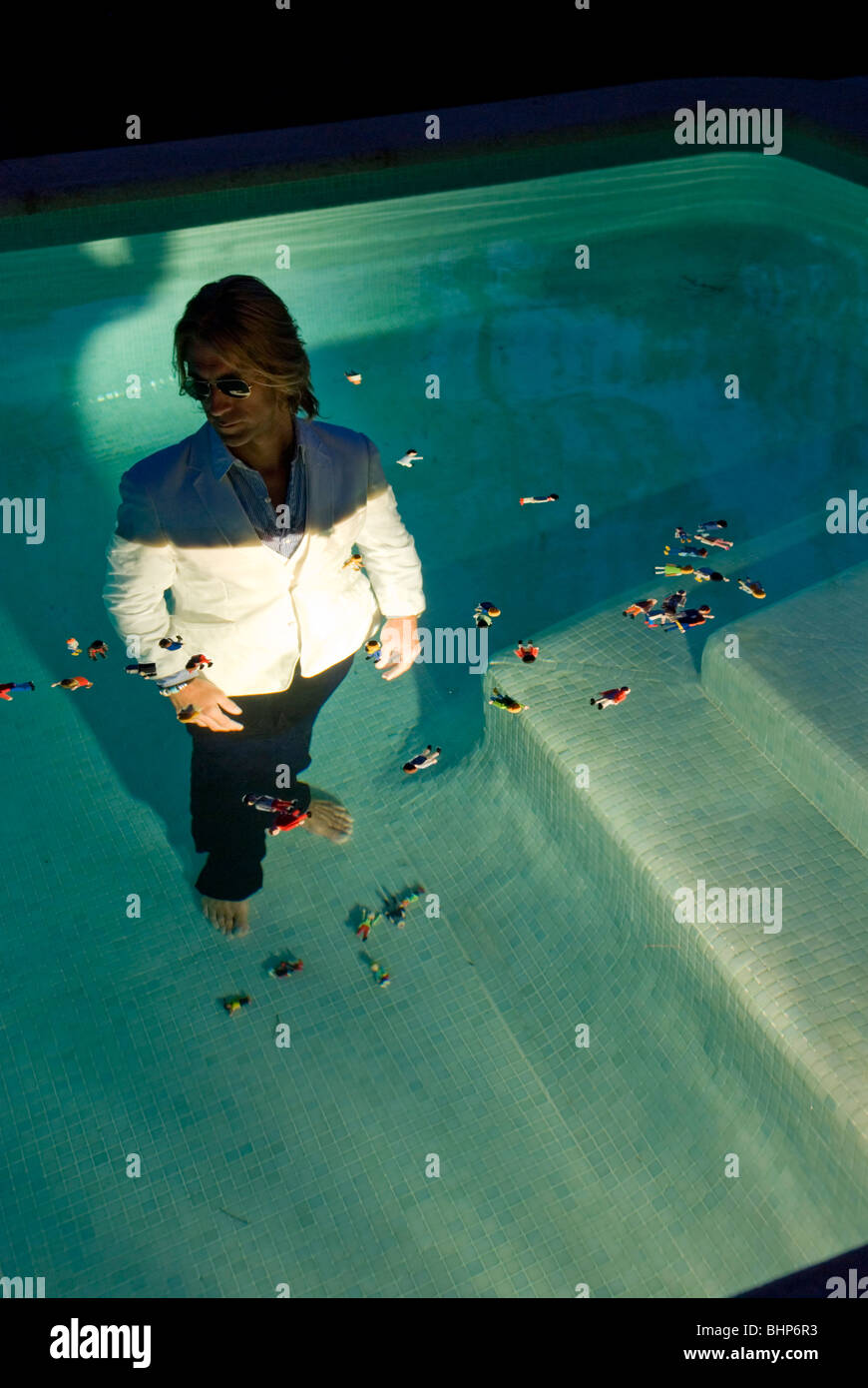 bizarre image of a suited blond man with sunglasses submerged in a ...