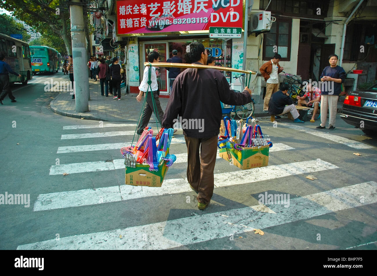 Man carrying goods on a street at Shanghai, China Stock Photo - Alamy