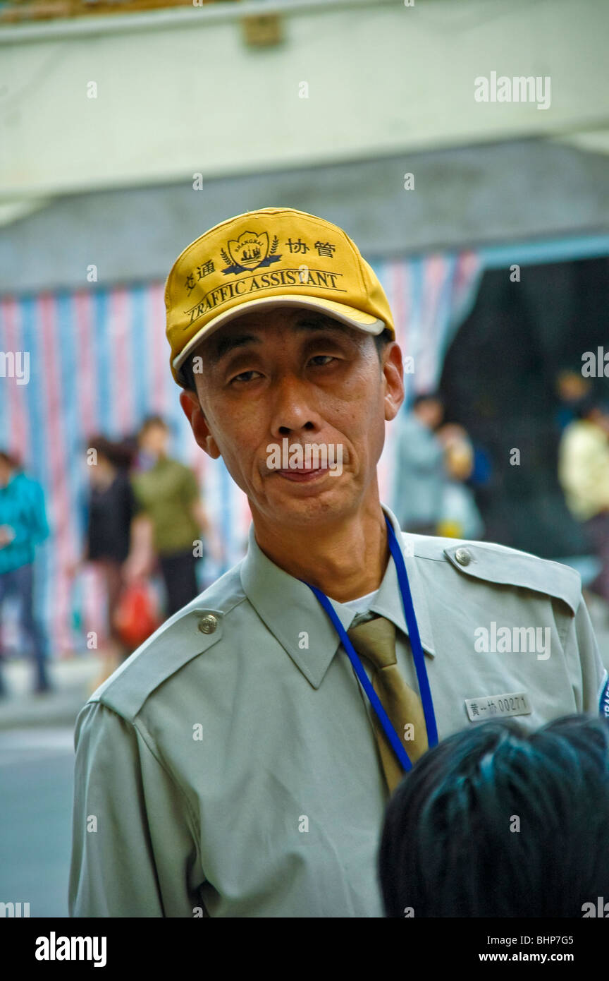 Portrait of chinese traffic assistant in the streets of Shanghai, China ...