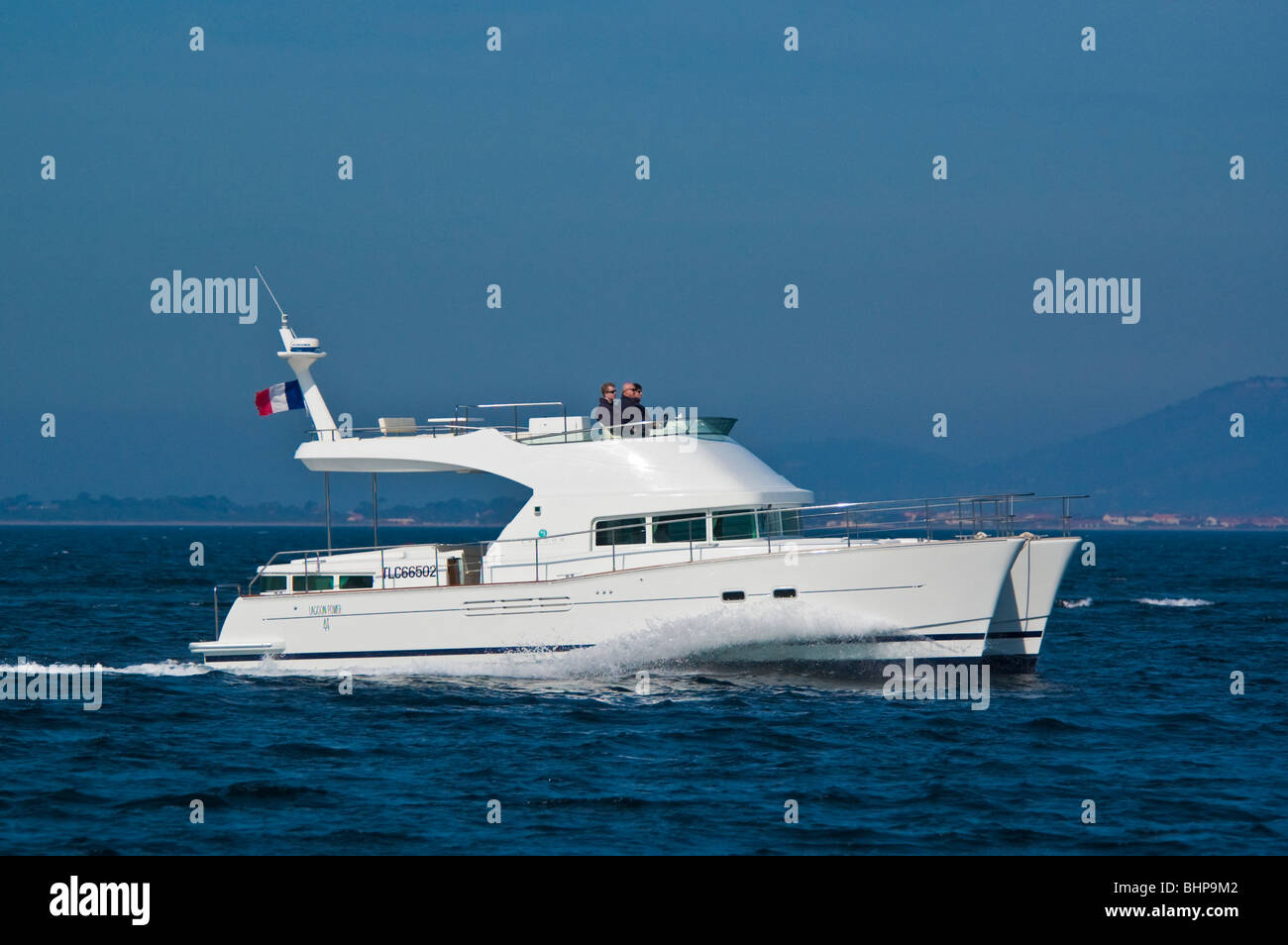 Side view of Lagoon 44 Power catamaran, yacht, Mediterranean Sea, coast ...