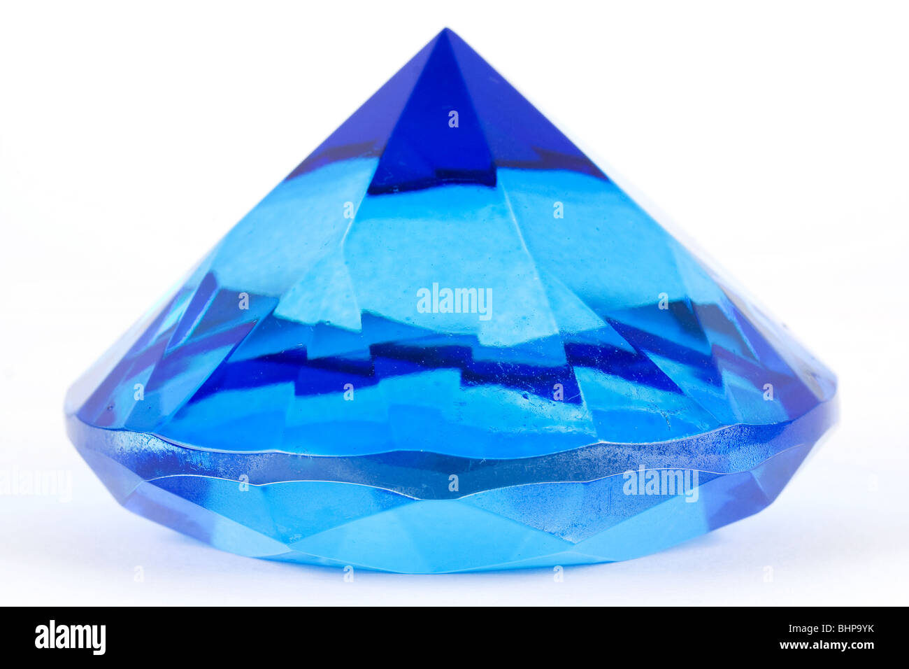 Blue glass polyhedron toy isolated on white background Stock Photo - Alamy