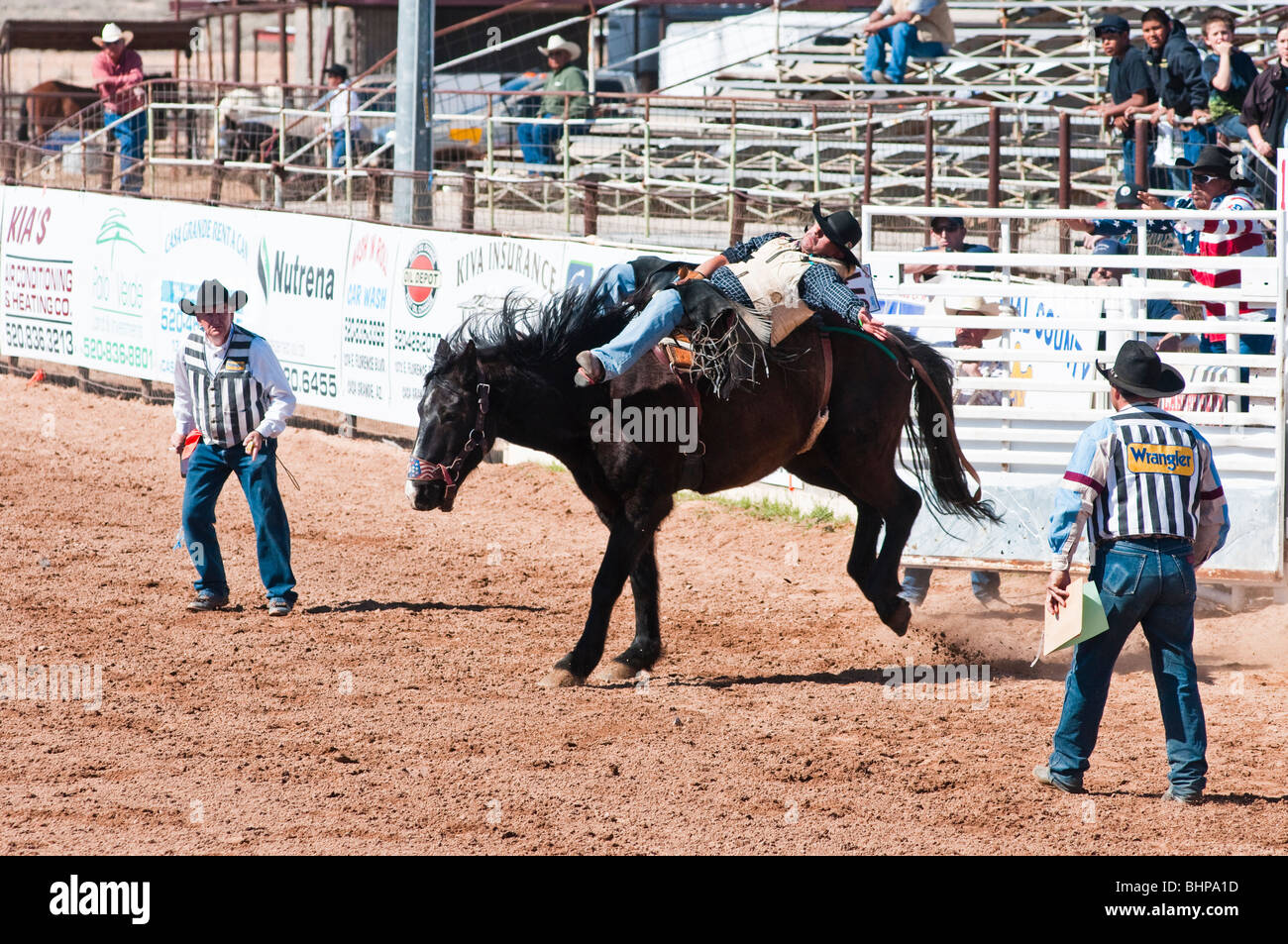 a cowboy competes in the saddle bronc riding event during the O'Odham ...