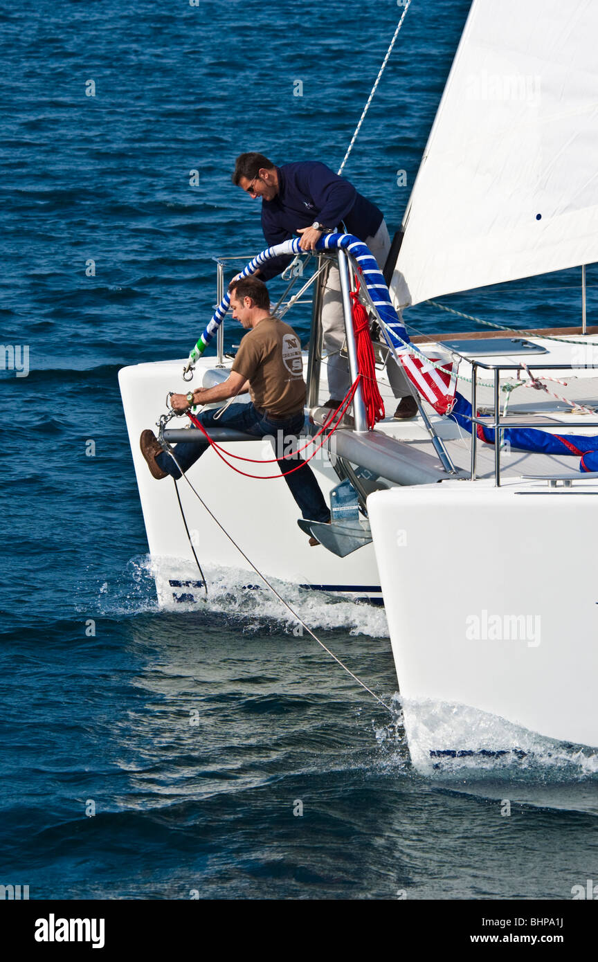 Sailors preparing spinnaker / gennaker / blister on a Lagoon 500 ...