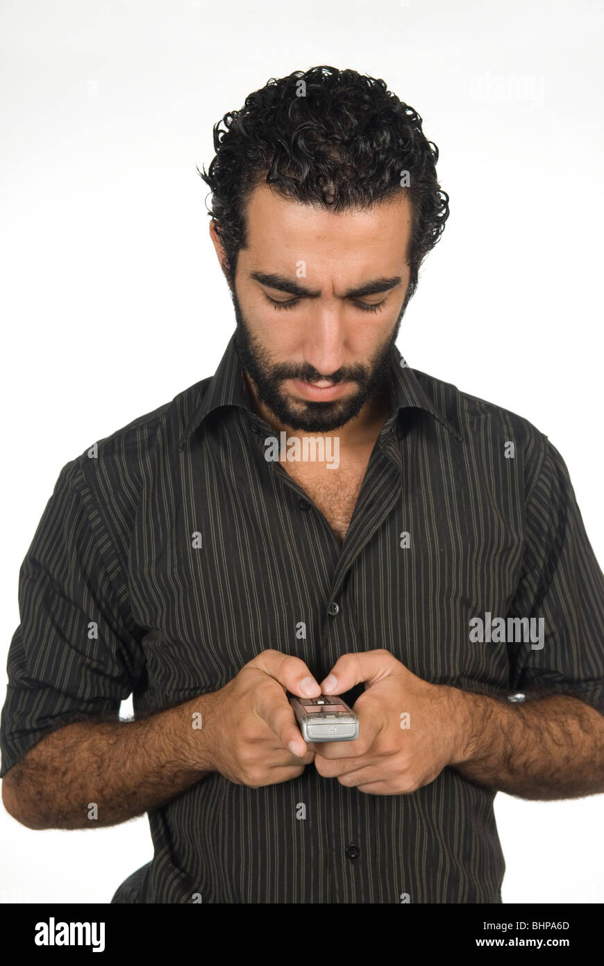 25 years old Middle Eastern man typing a text message on mobile phone ...