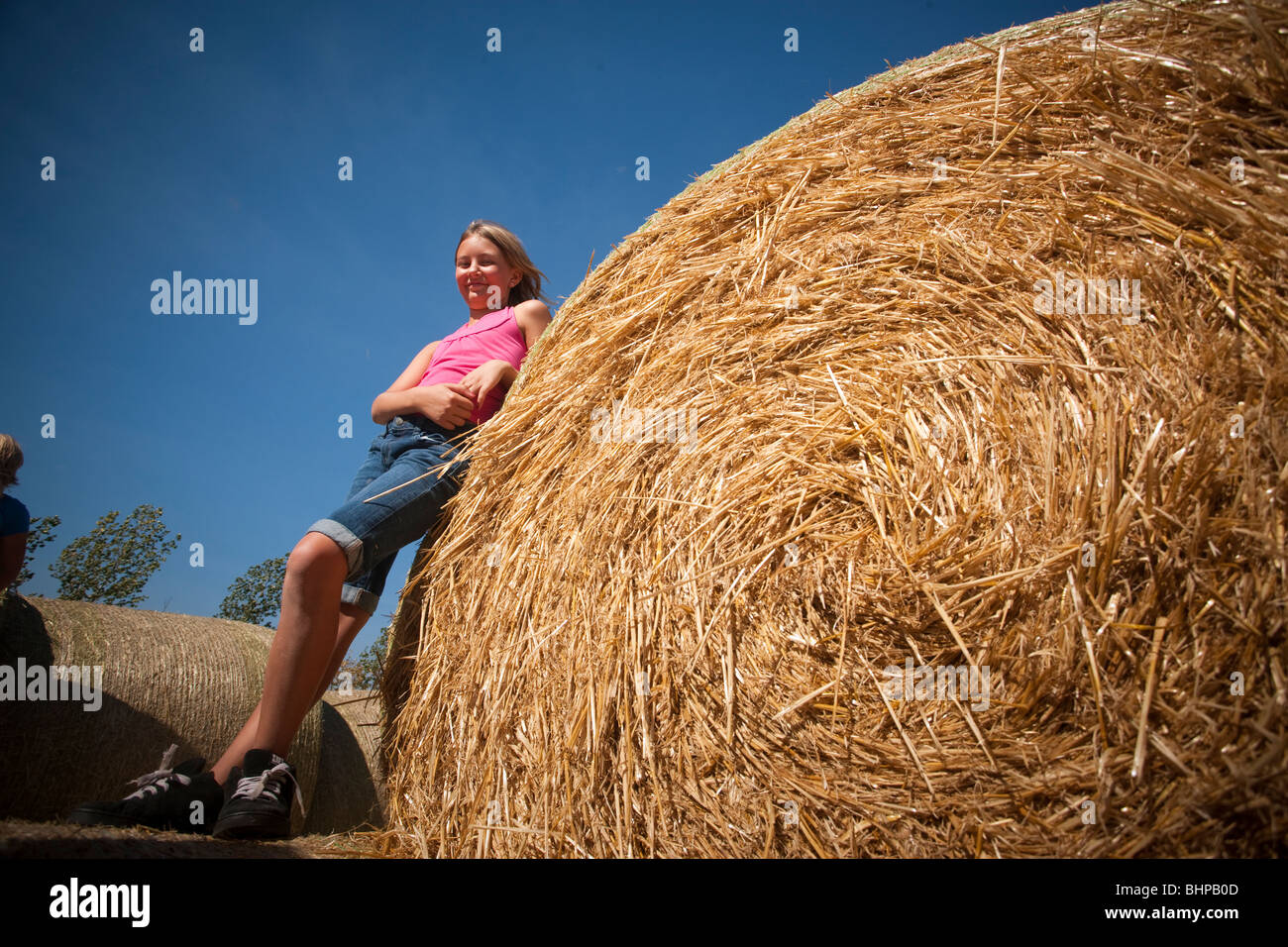 Girl (10) Beside Large Straw Bale; Redvers, Saskatchewan, Canada Stock ...