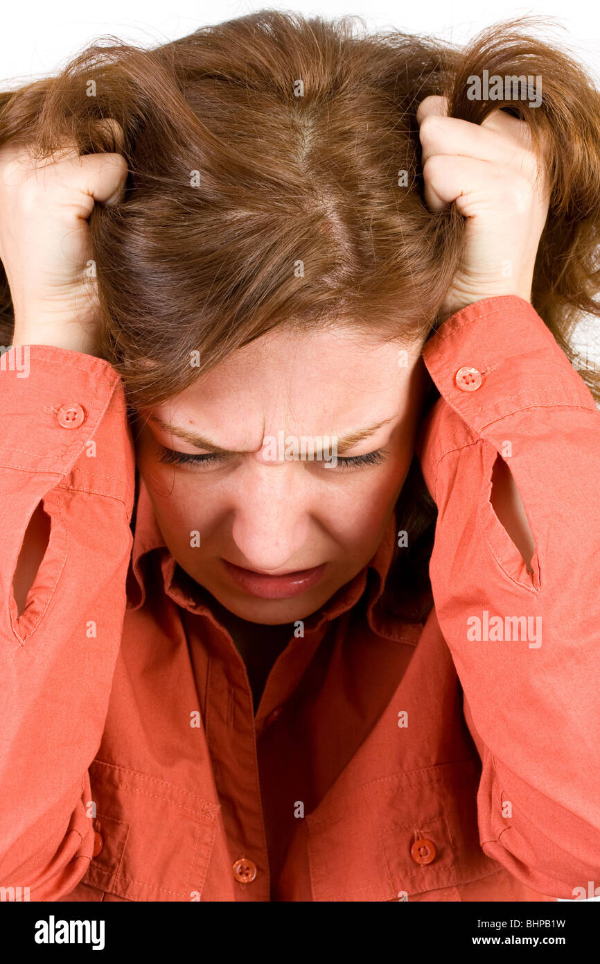 Portrait of a young woman pulling her hair, isolated on white ...