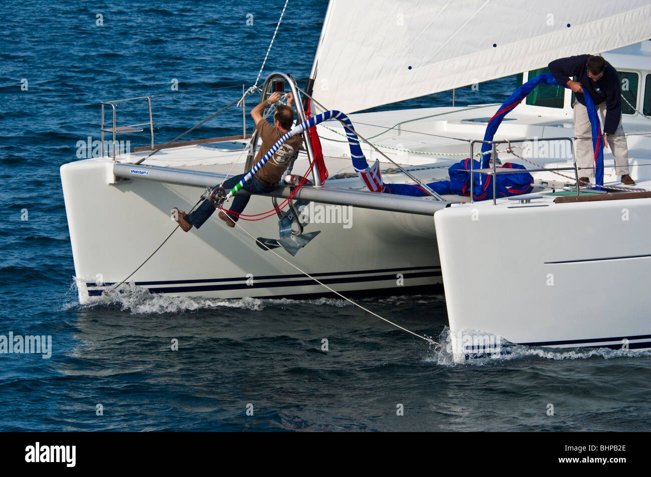 Sailors preparing spinnaker / gennaker / blister on a Lagoon 500 ...