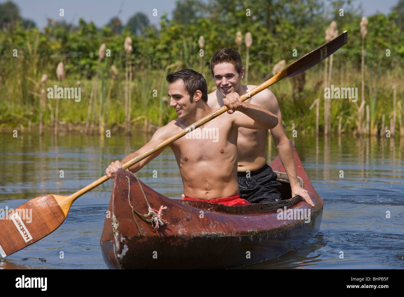 Two young men on a lake in a kayak Stock Photo - Alamy